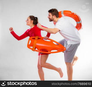 Accident prevention and water rescue. man and woman lifeguard couple on ...