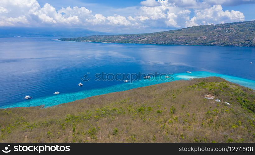 Aerial view of the Sumilon island, sandy beach with tourists swimming ...
