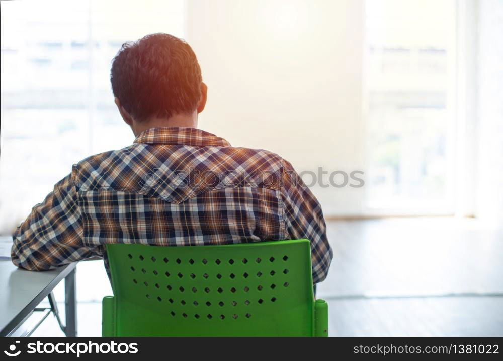 back side of asian man sitting one person on chair lean table in ...