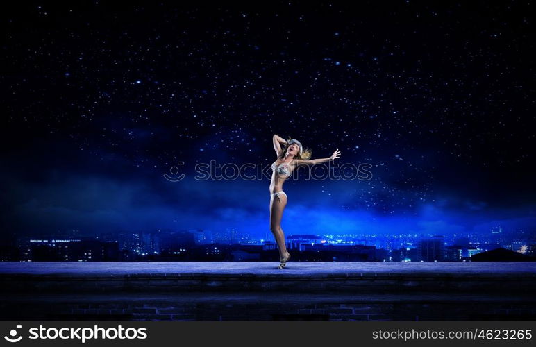 Bikini girl. Hot young dancing woman in white bikini on night city ...