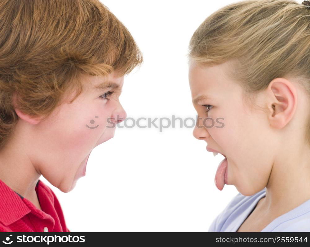 Brother shouting at sister sticking her tongue out — Stockphotos.com