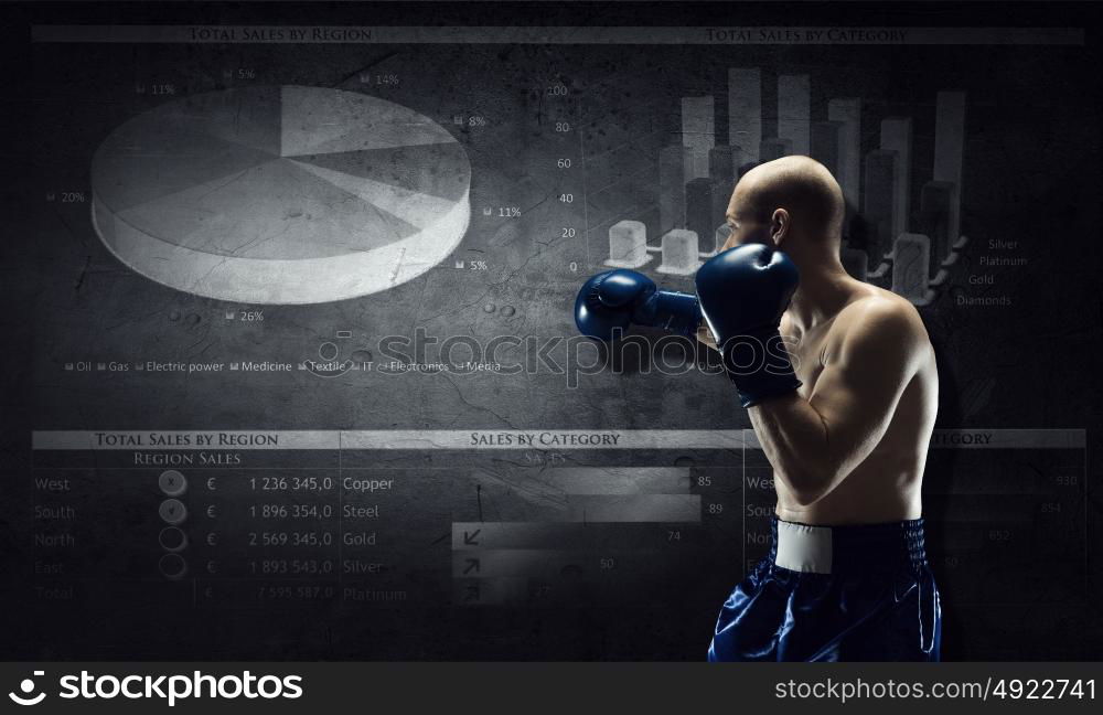 Fighting for sales dynamics. Muscular boxer man over dark background ...