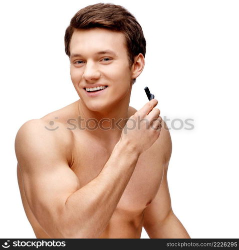 Handsome young man sniffing his armpit isolated on white. Handsome ...