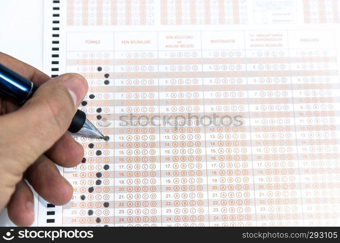 Man hand marks ,fill out answer with pencil on Test score sheet with ...