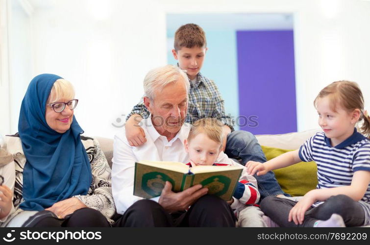 modern muslim family grandparents with grandchildren reading Quran and ...