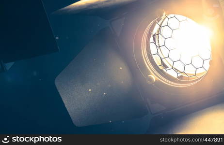 Professional orange studio spotlight hanging on the ceiling. Lighted ...