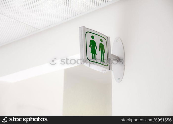 Public modern white and green restroom sign on white wallPublic modern ...