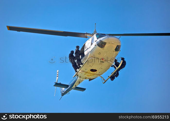 Special forces team ready for helicopter rope jumping, unmarked and ...