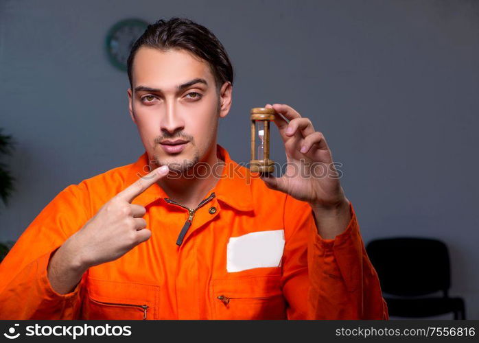 The young convict man sitting in dark room. Young convict man sitting ...