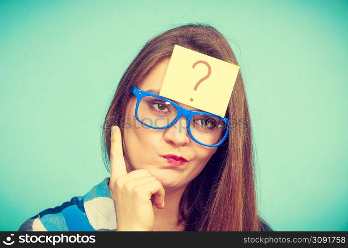 Thinking woman with big nerdy eyeglasses and question mark on forehead ...
