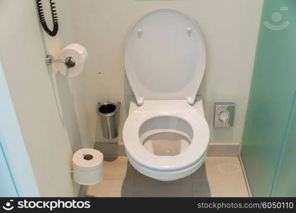 toilet in a modern building with a wall-hung toilet, built-in water ...