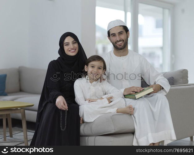 Traditional muslim family parents with children reading Quran and ...