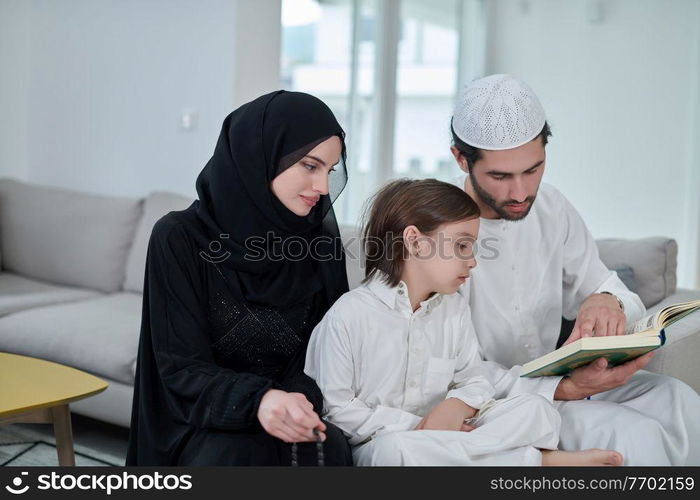Traditional muslim family parents with children reading Quran and ...