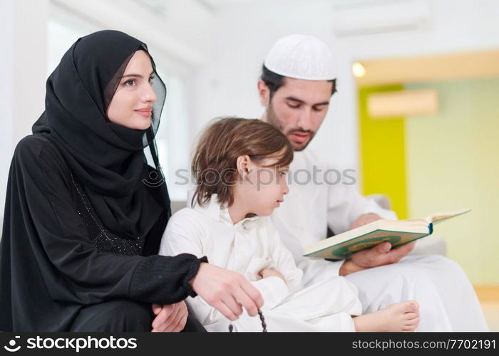 Traditional muslim family parents with children reading Quran and ...