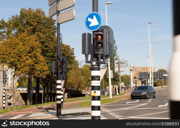 Traffic light-regulated intersection with road signs. Red traffic light ...